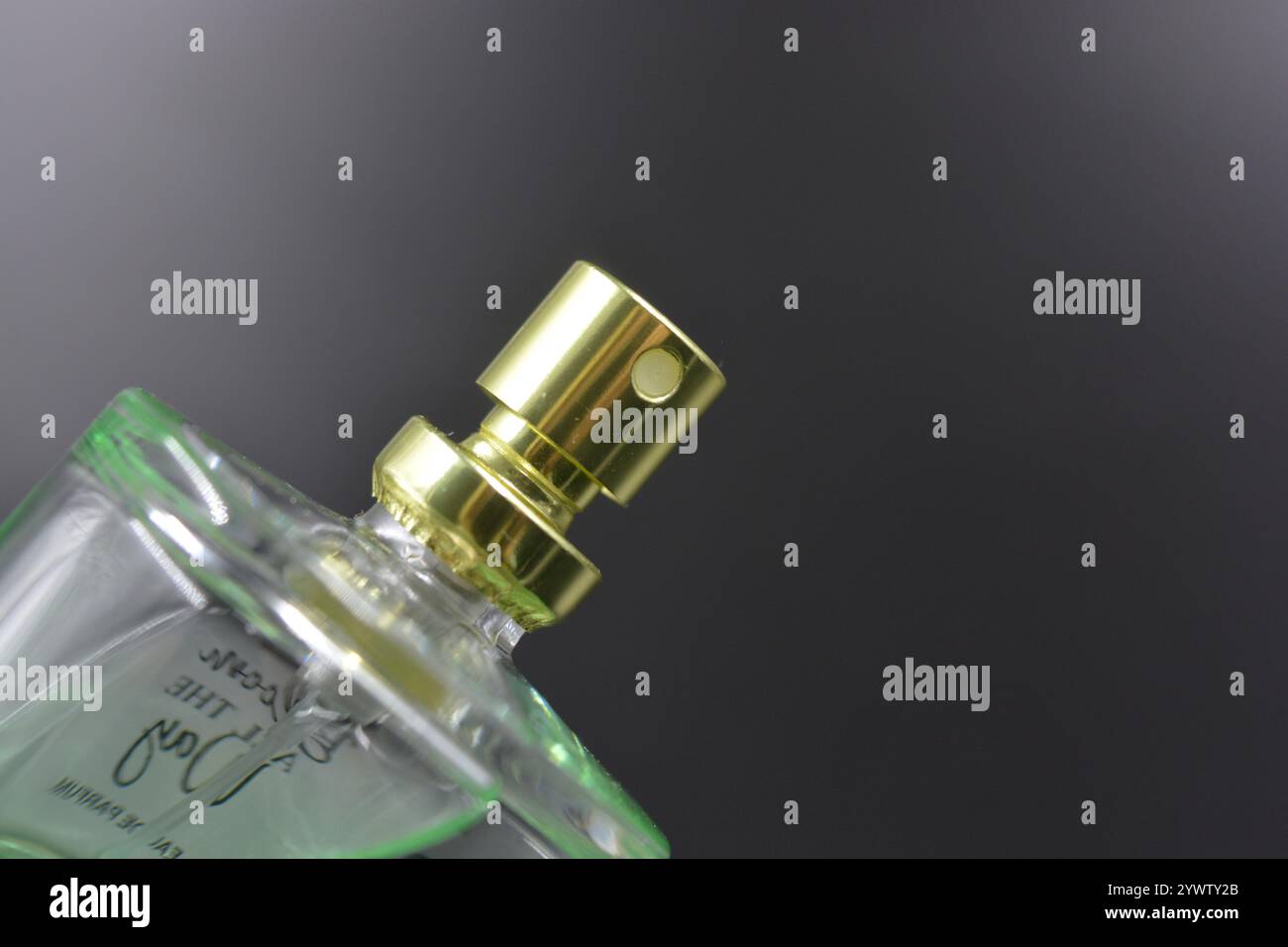 Women's clothes, perfumes, pleasant aromas. Glass bottle with green ...