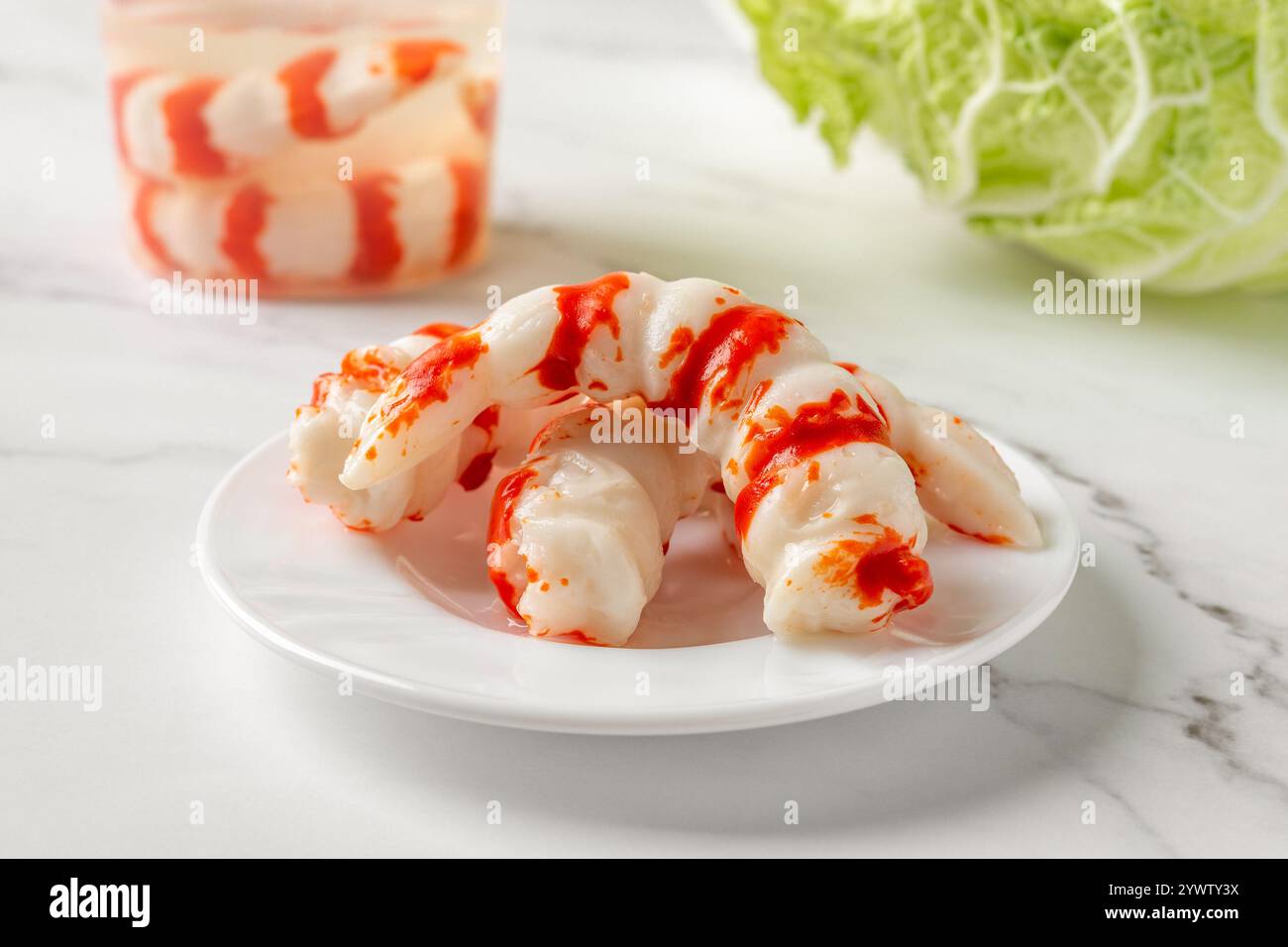 Shrimps from surimi on a plate over marble tabletop. Surimi shrimps as ...