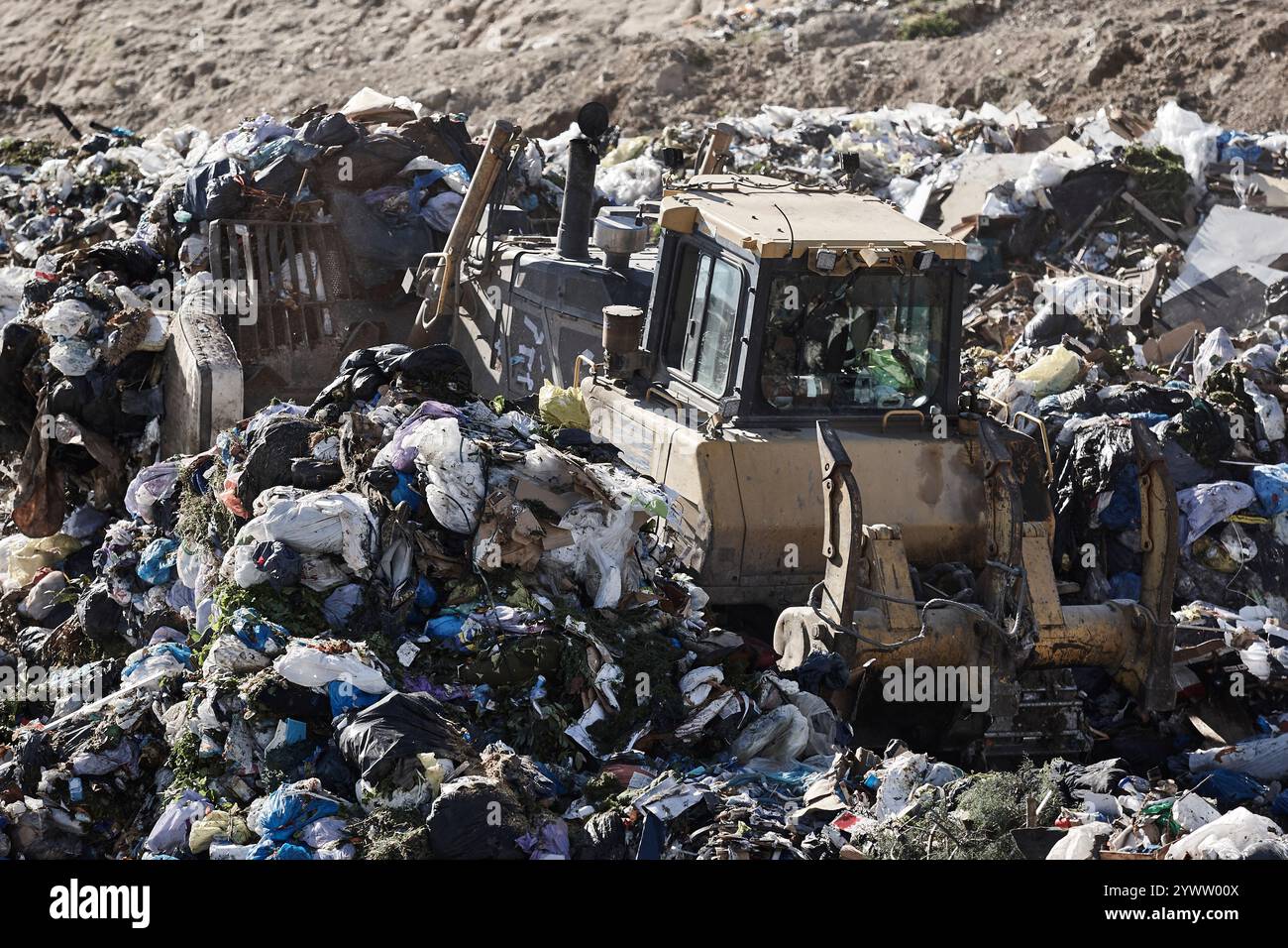 Heavy machinery shredding garbage in an open air landfill. Waste Stock ...