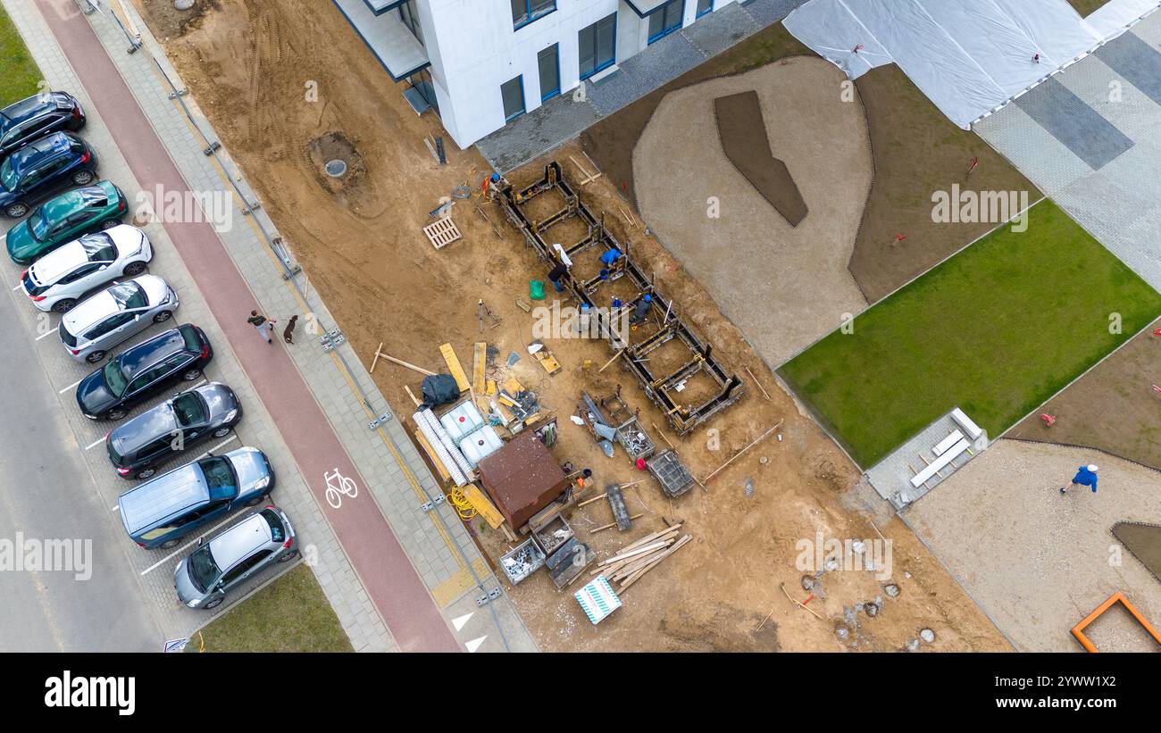 Aerial view of a construction site with workers building a foundation ...