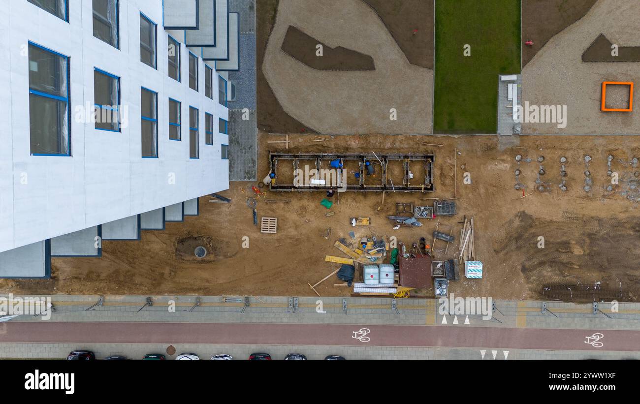 Aerial view of a construction site with workers building a foundation ...
