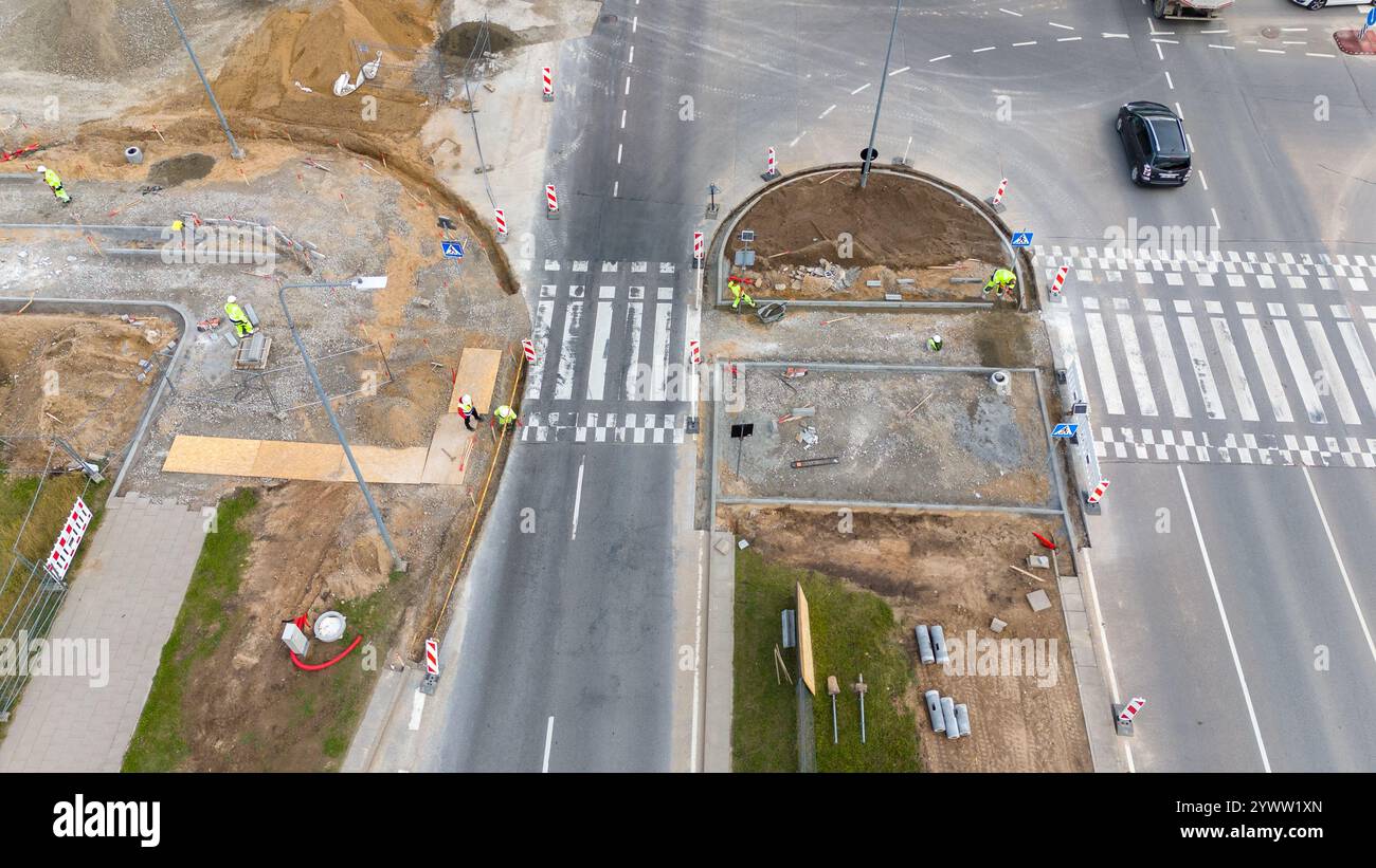 Aerial view of a road construction site with workers and machinery ...