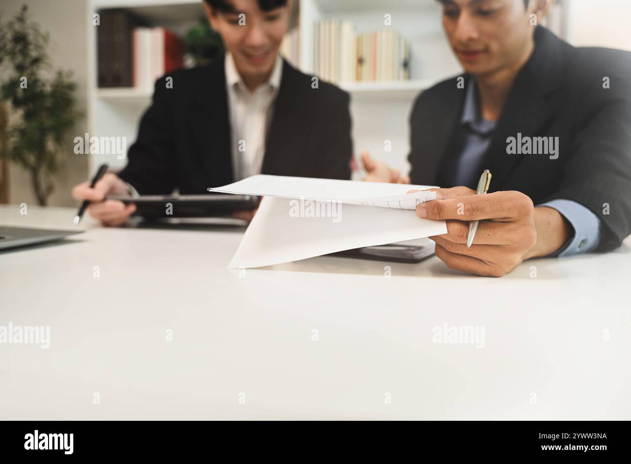 Financial advisor reviewing important documents with a client at a ...