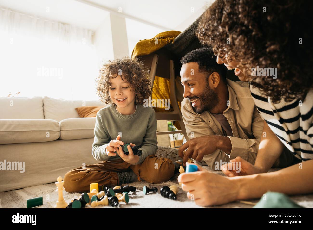A joyful moment of a family laughing and playing games together in a ...