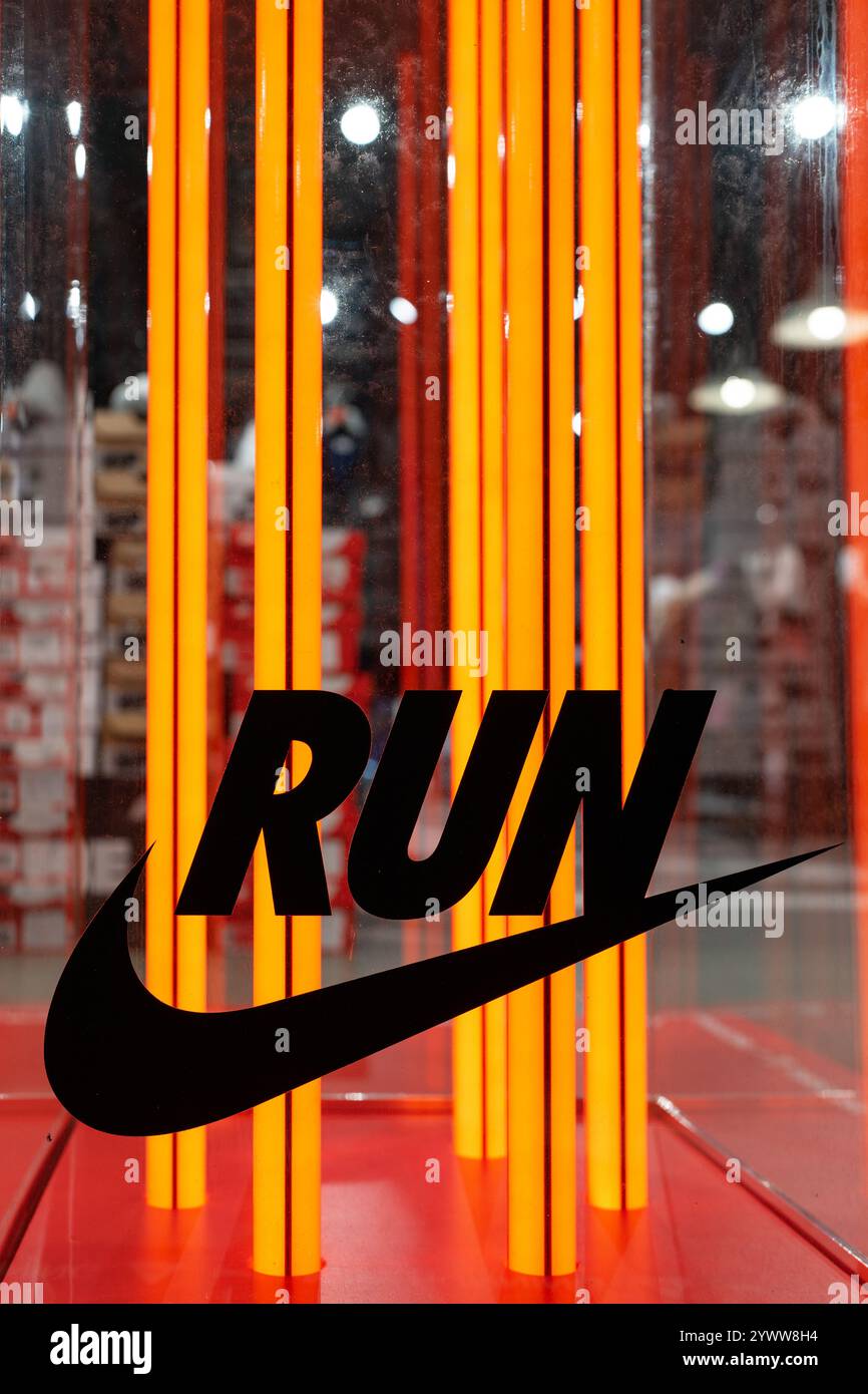 NIKE logo. Neon Nike logo in the interior of the Nike brand store. Nike ...