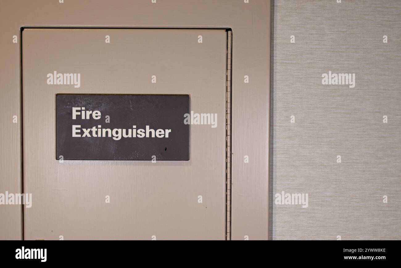 Fire extinguisher sign on hinged door in a wall Stock Photo - Alamy