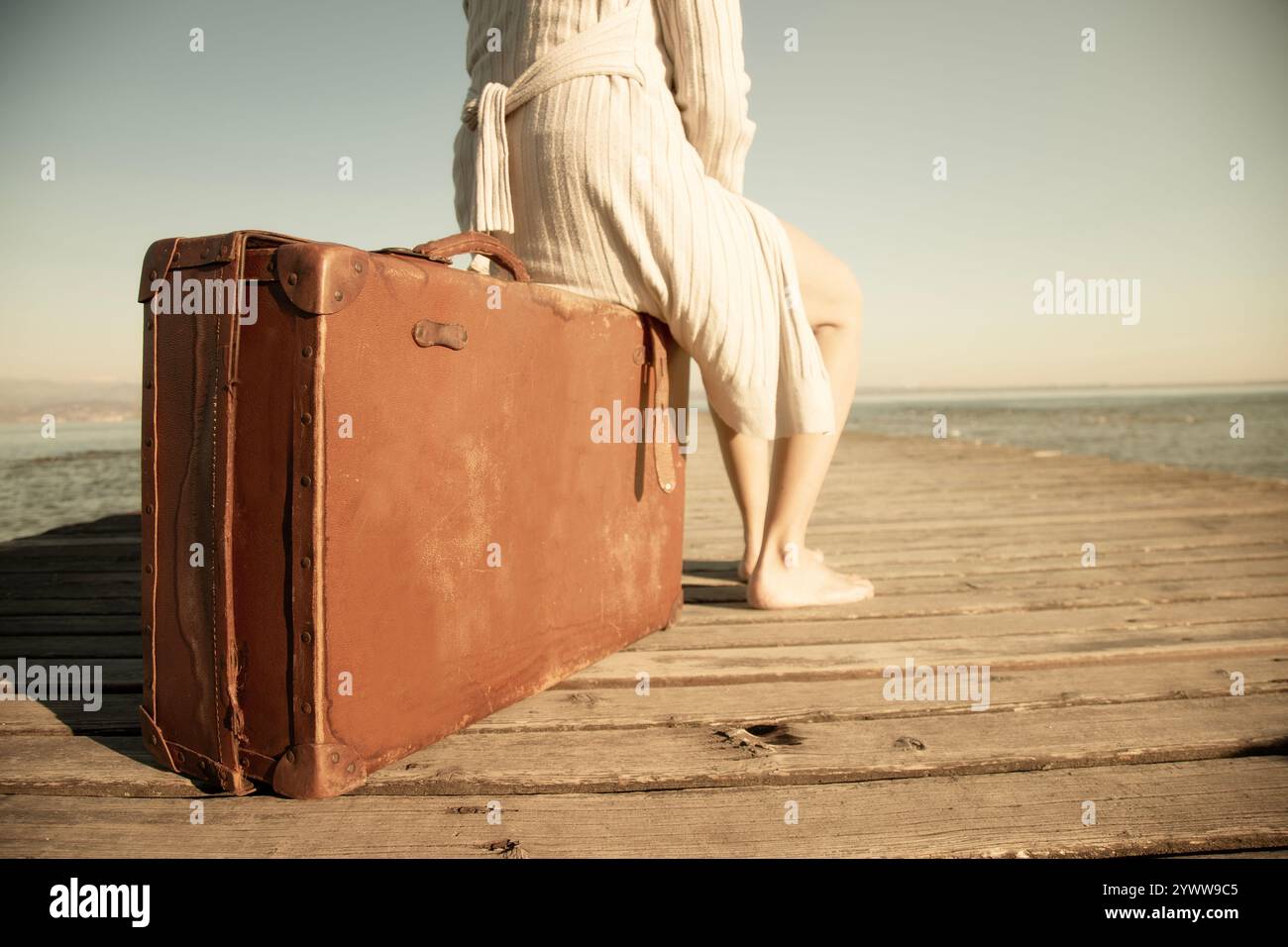 woman with suitcase waiting on a pier to leave Stock Photo - Alamy