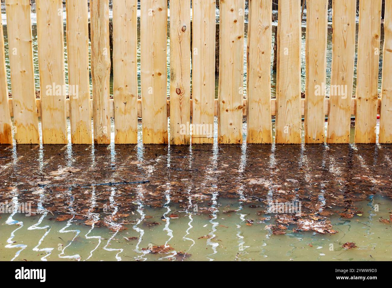 Wooden fence partially submerged during flood Stock Photo - Alamy