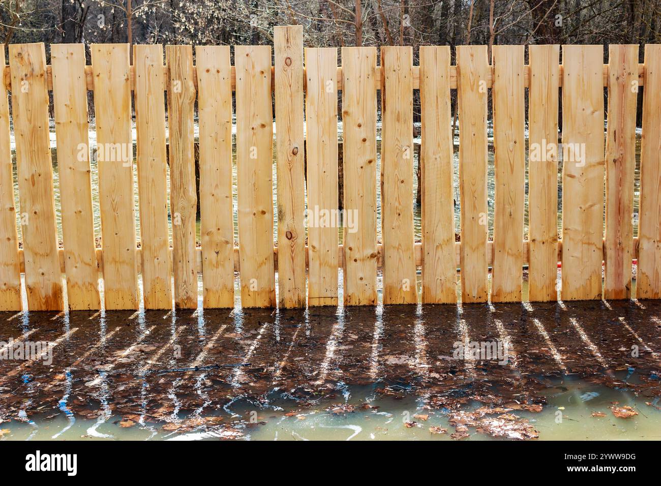 Wooden fence partially submerged during flood Stock Photo - Alamy
