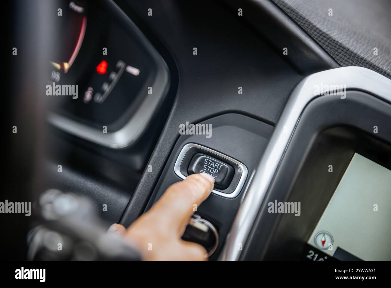 Start stop engine button, car driver starting the car Stock Photo - Alamy