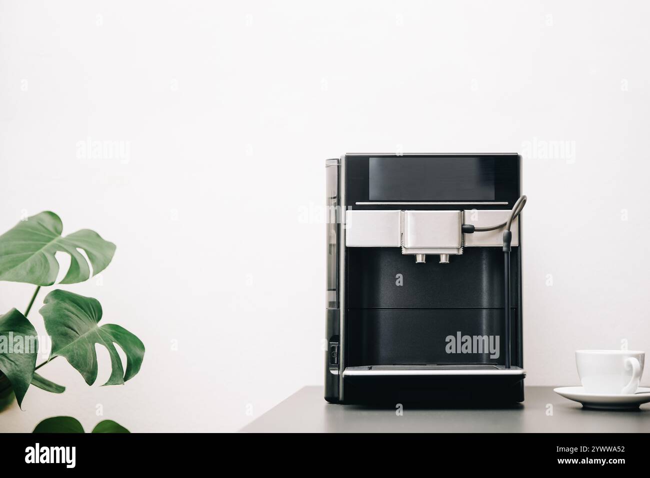 Coffee machine on the desk in the office, clean interior with coffe ...