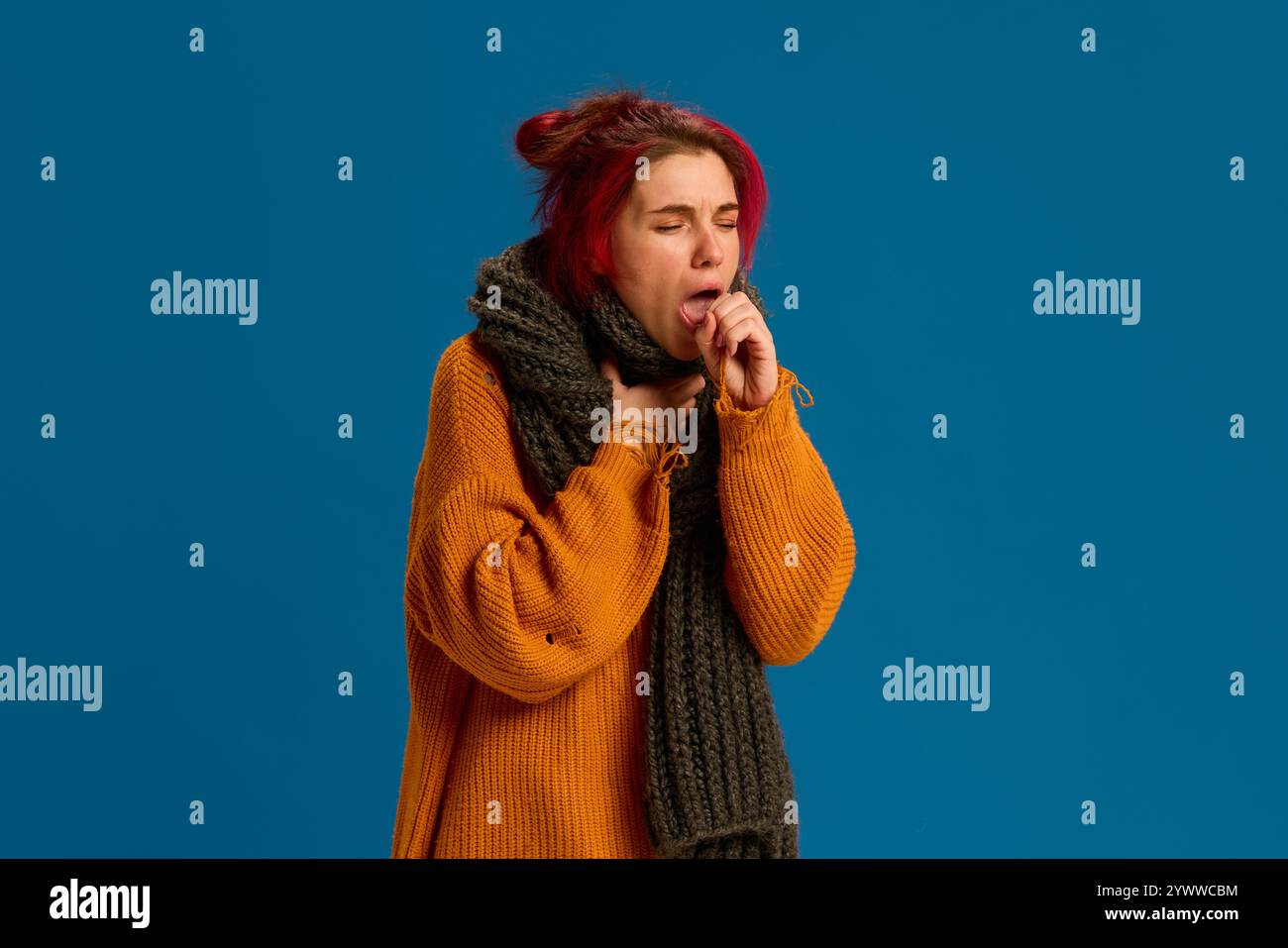 Portrait of very sick, ill young woman wrapped in scarf, dressed ...