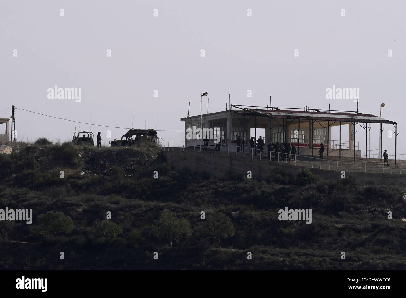 Israeli soldiers stand next to army vehicles along the so-called Alpha ...