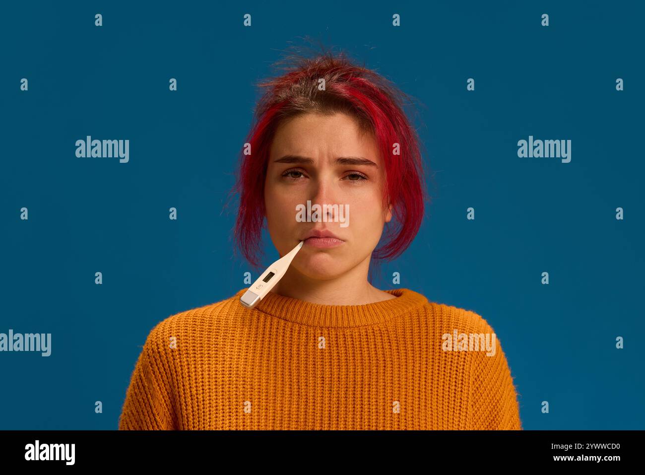 Portrait of sad, depressed young woman with thermometer in mouth ...