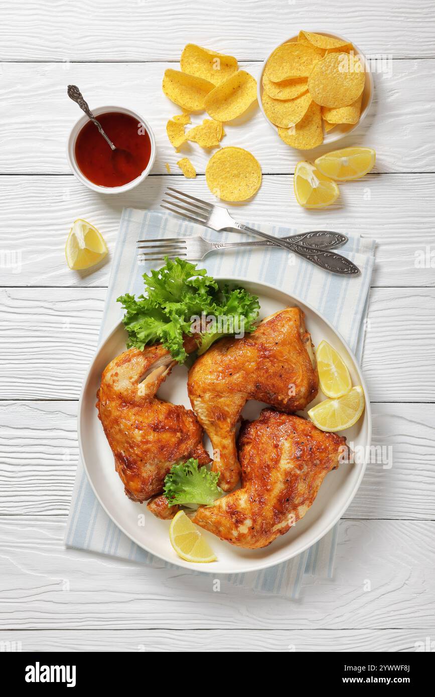 baked in oven three chicken leg quarters on white dish on white ...