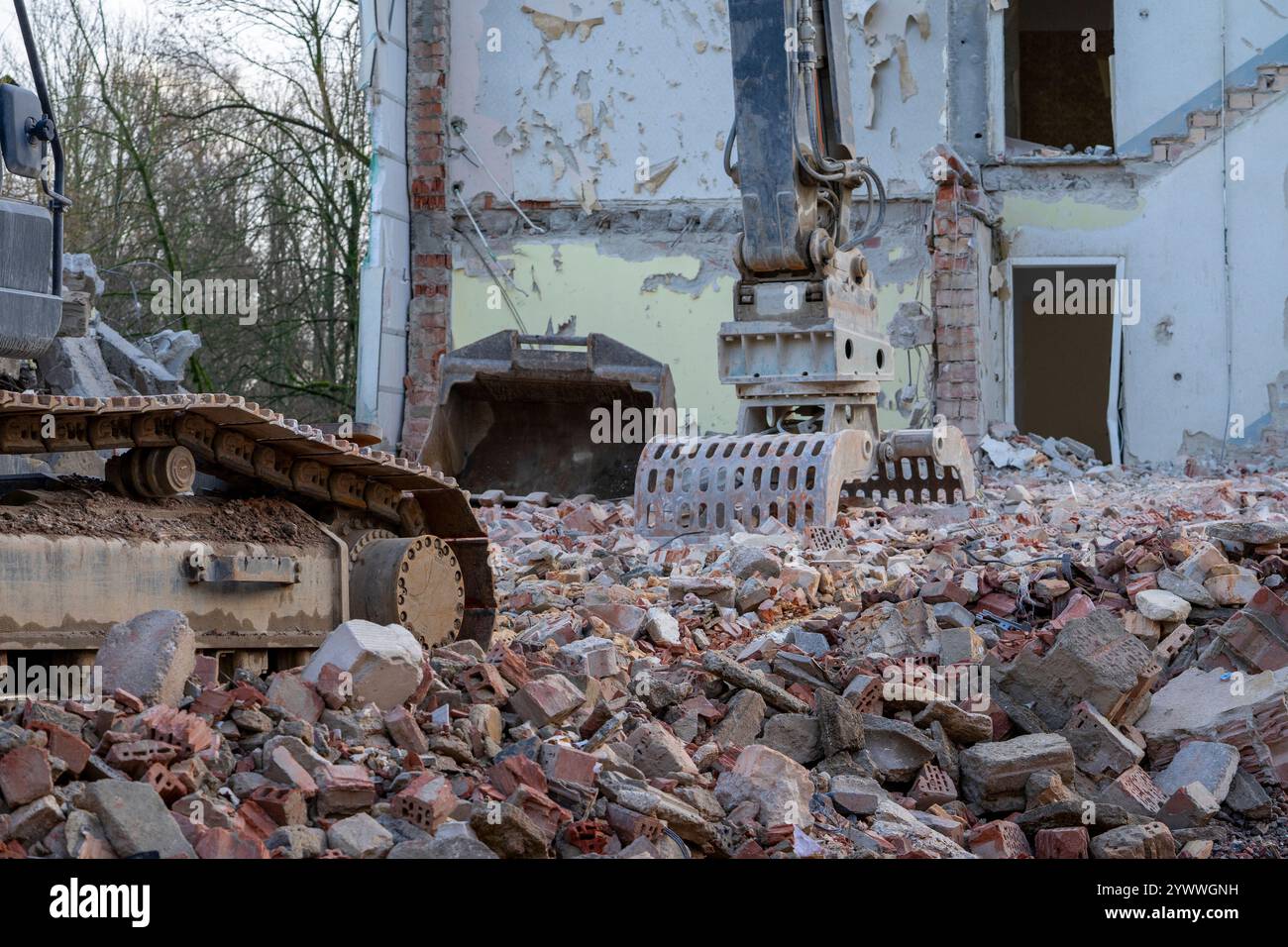 demolition of an abandoned building factory with maschine Stock Photo ...