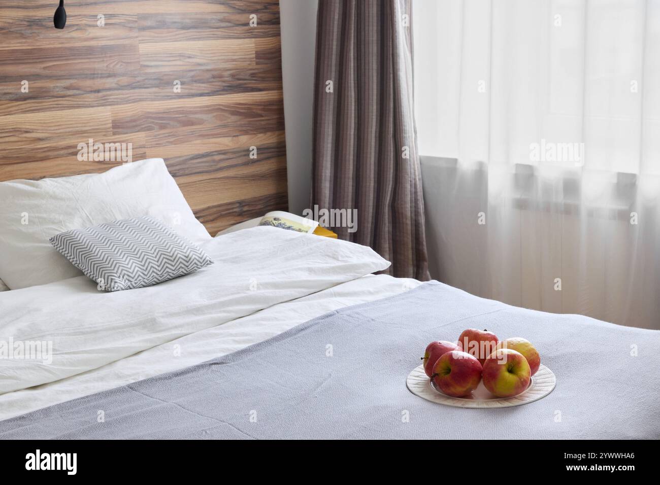 A Cozy and Inviting Bedroom Featuring Fresh Apples on the Bedside Table ...