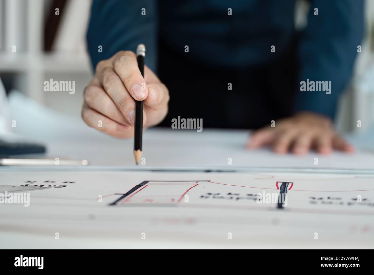 Engineer analyzing architectural blueprint in modern office environment ...