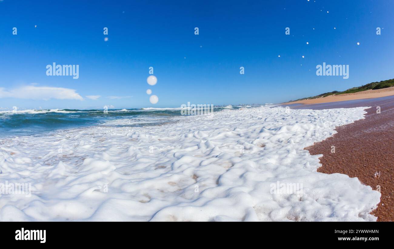 Beach ocean waves crashing onto shore break sand with white blue water ...