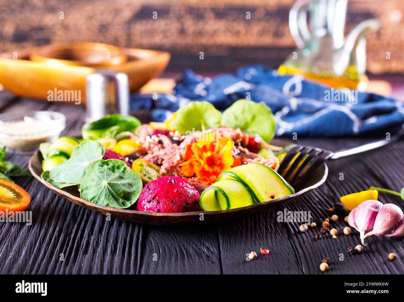 Meat steak decorated with nasturtium flowers. Sliced roasted pork steak ...