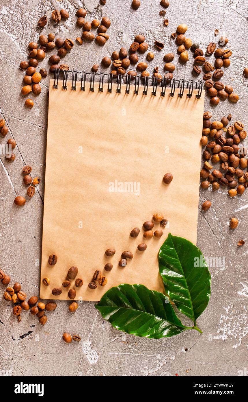 Roasted coffee beans with note on a table, background Stock Photo - Alamy