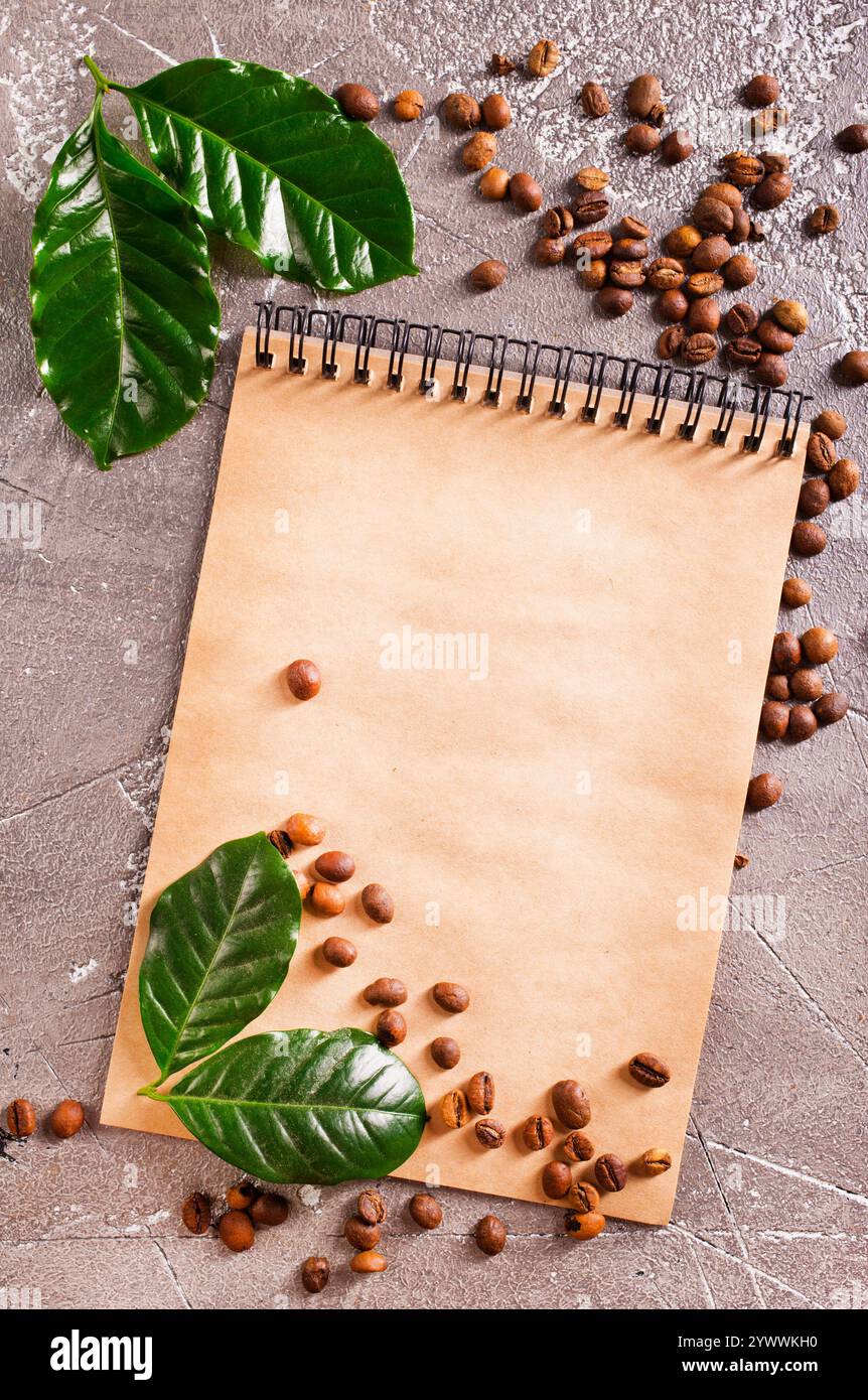 Roasted coffee beans with note on a table, background Stock Photo - Alamy