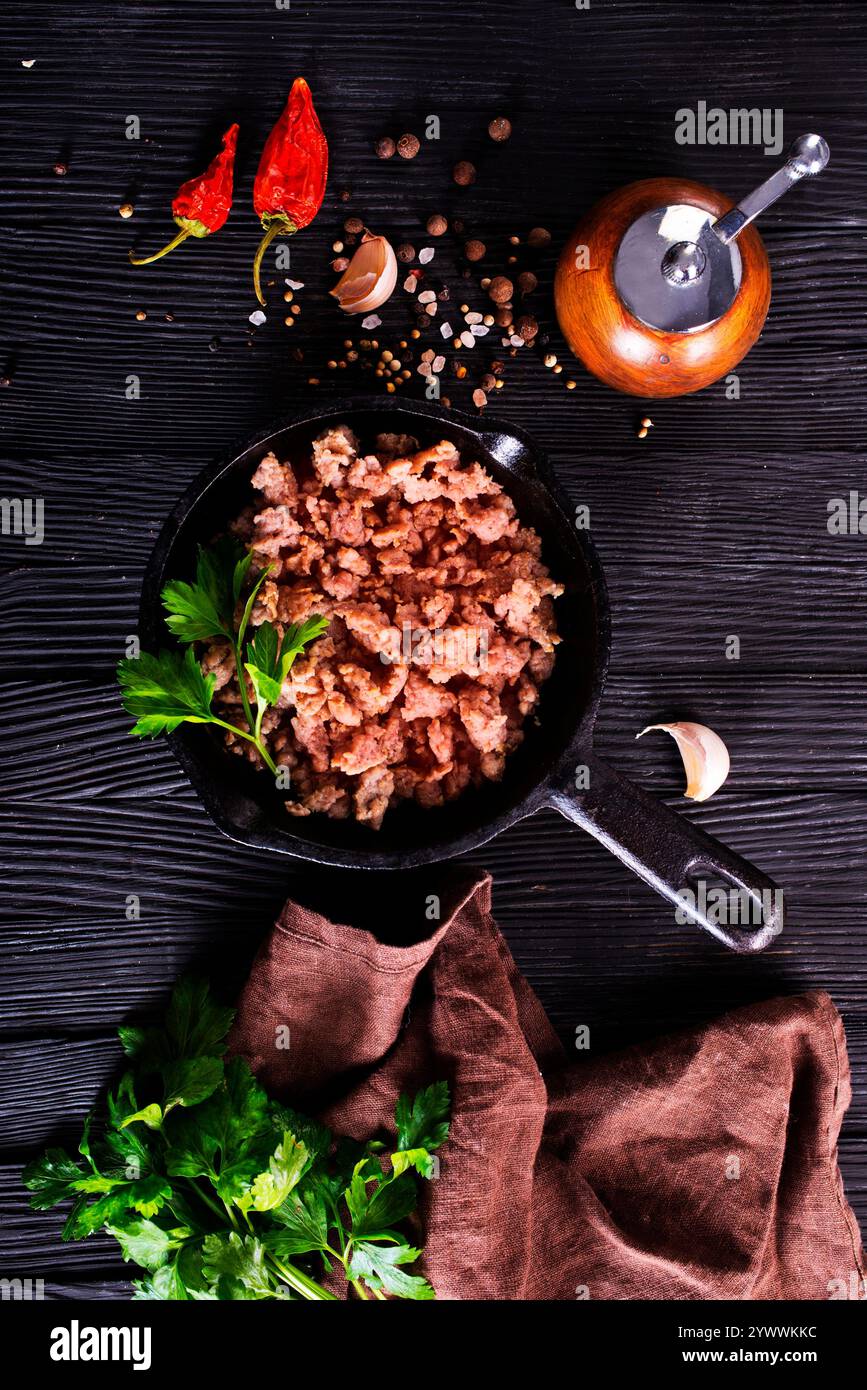Pan fried minced meat in pan, Gray background. Top view Stock Photo - Alamy