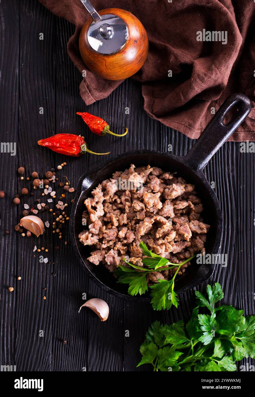 Pan fried minced meat in pan, Gray background. Top view Stock Photo - Alamy