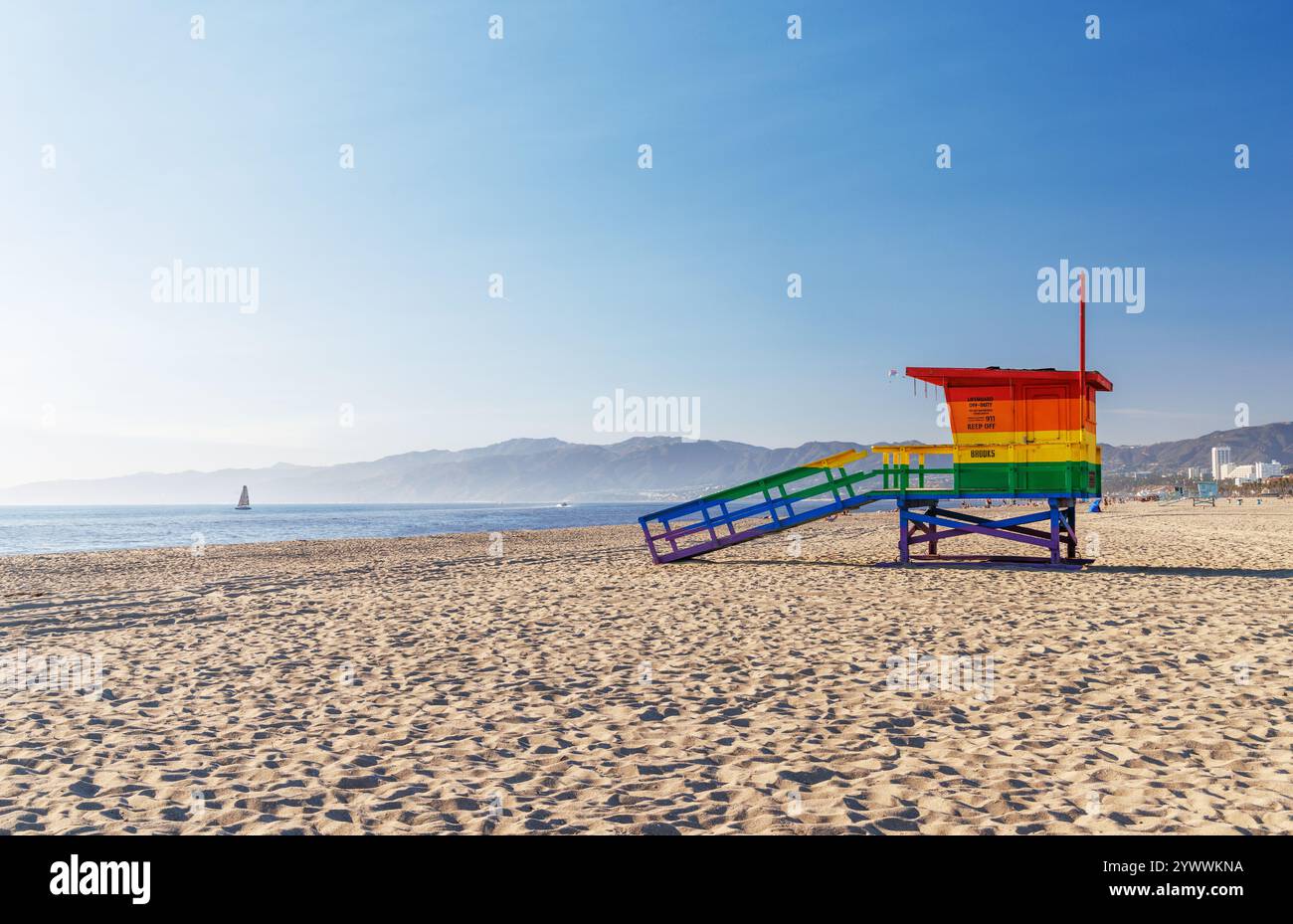 Vibrant lifeguard tower painted in LGBTQ rainbow colors, standing ...