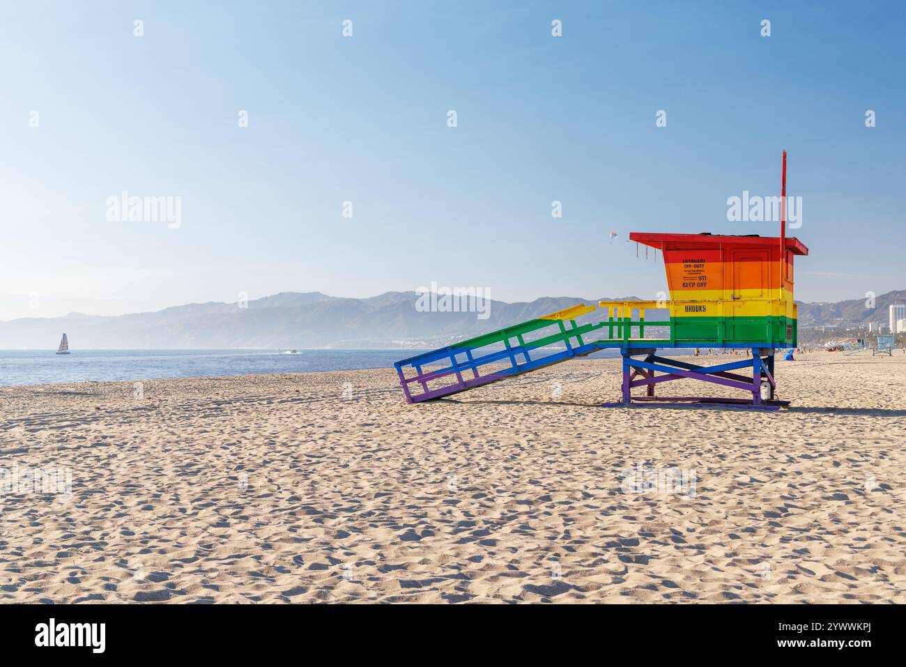Vibrant lifeguard tower painted in LGBTQ rainbow colors, standing ...