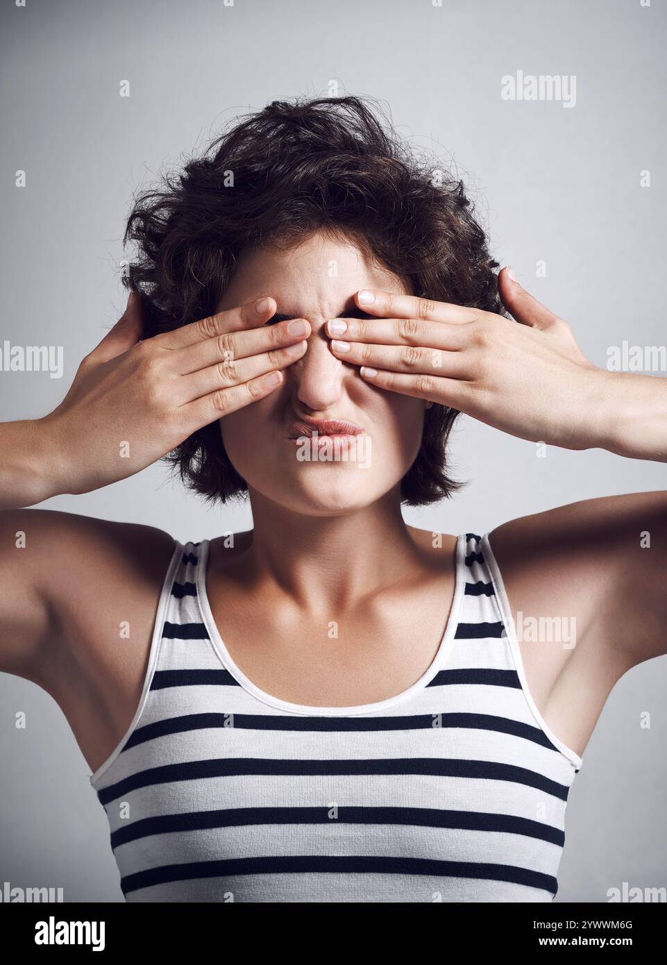 Hands, cover eyes and face of woman in studio for facial expression ...