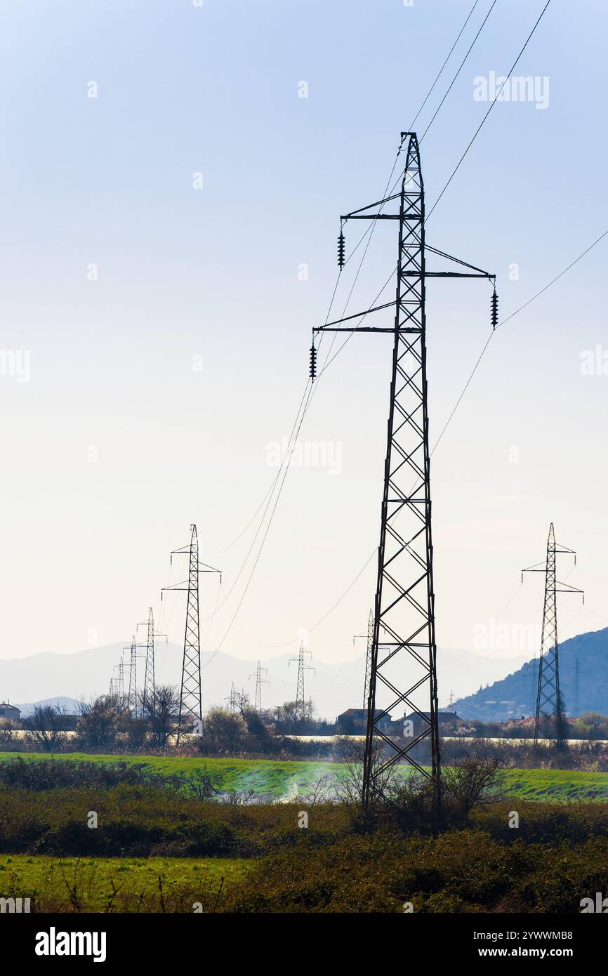 High-voltage power lines in the valley stretching into the distance ...