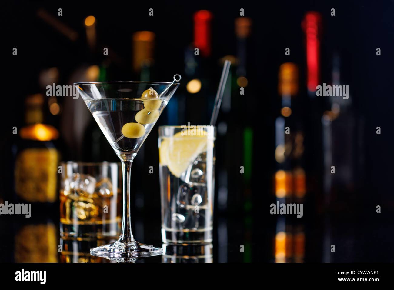 Various cocktails on a bar table. The colorful bokeh of illuminated ...