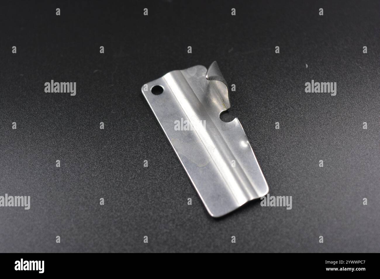 Unusual metal things, a metal fragment for canned food is located on a ...