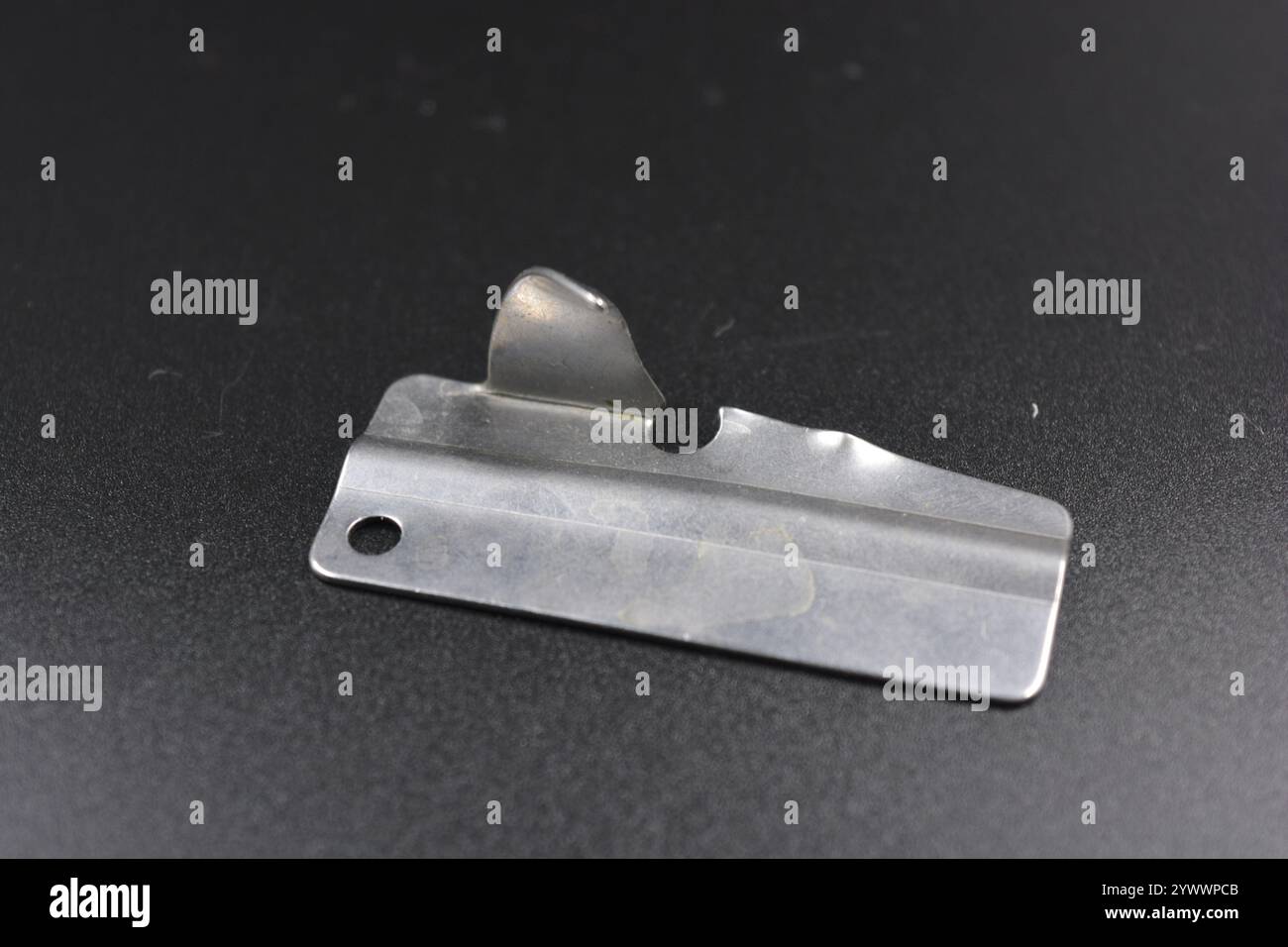 Unusual metal things, a metal fragment for canned food is located on a ...