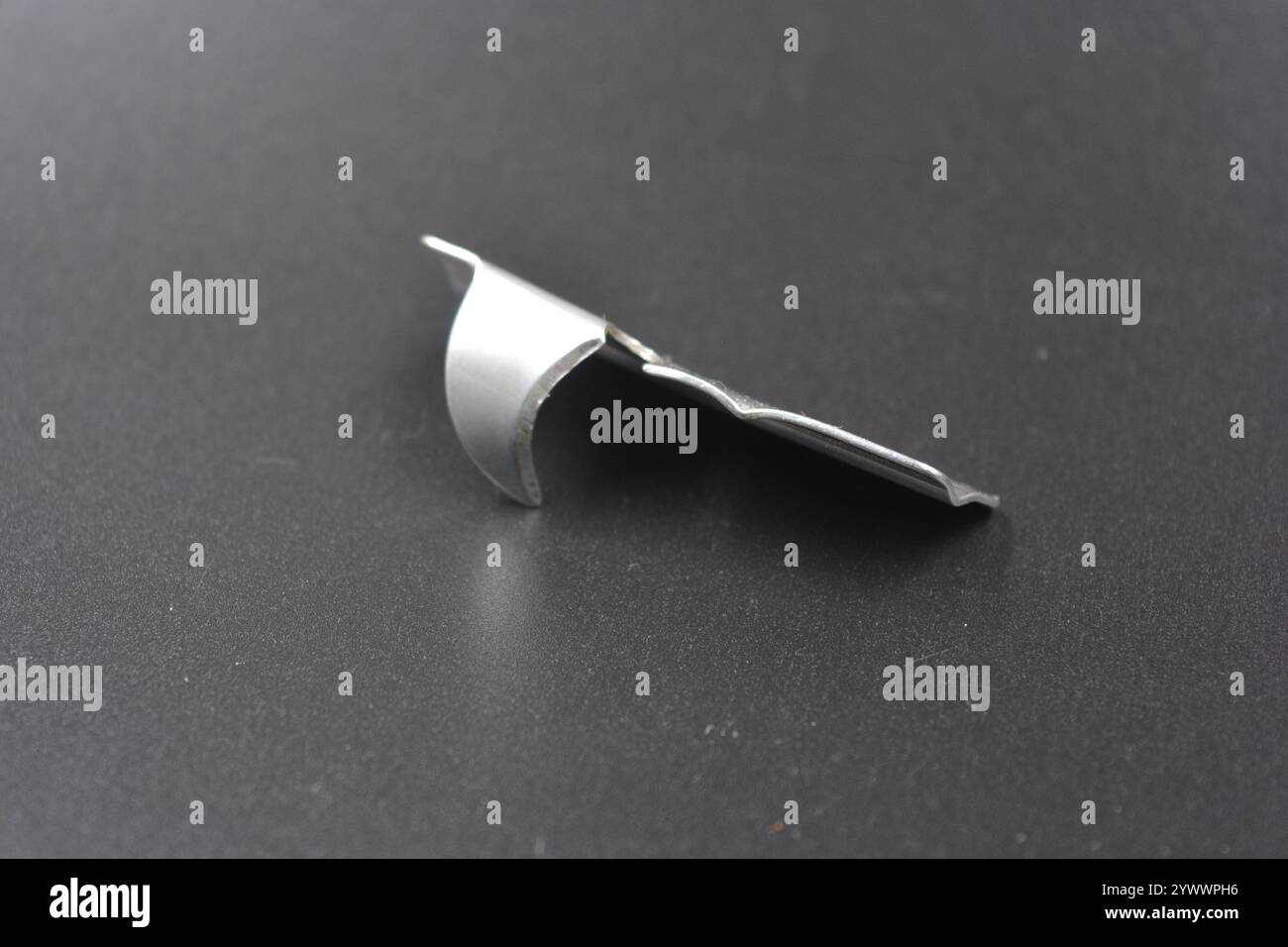 Unusual metal things, a metal fragment for canned food is located on a ...