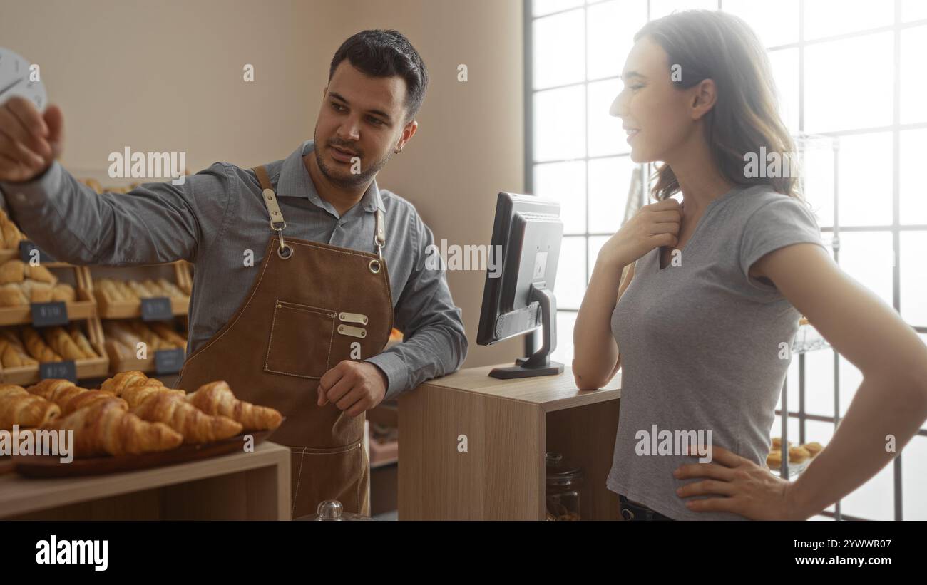 Baker pointing bread customer hi-res stock photography and images - Alamy