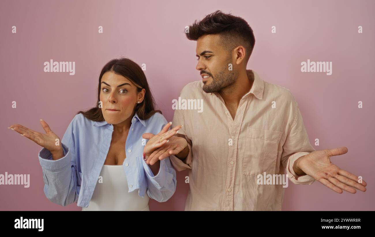 Man and woman shrugging in confusion against a pink background ...