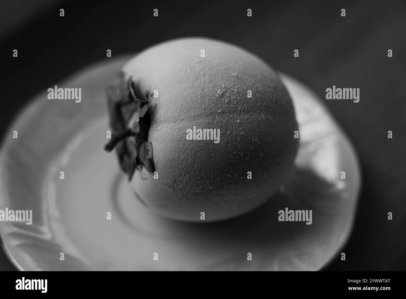 Frozen persimmon on a saucer. Persimmon covered with frost Stock Photo ...
