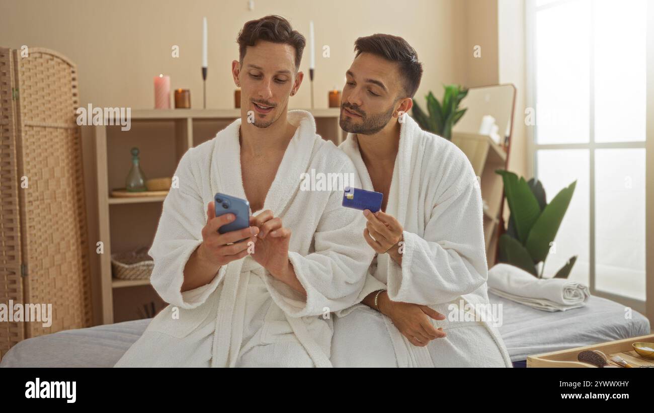 Men relaxing in a spa wearing white robes, using a smartphone and ...