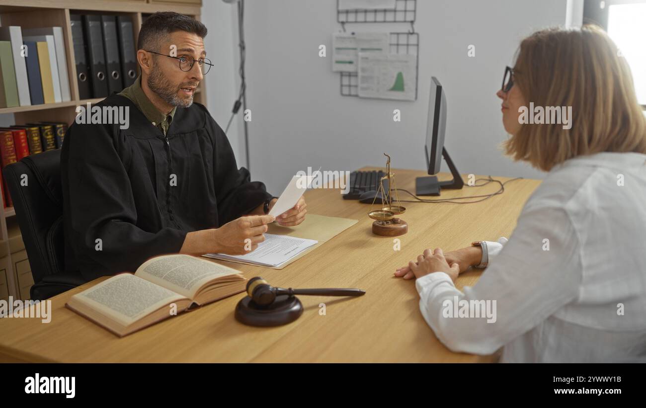 Male judge talking with female client in an office setting with legal ...