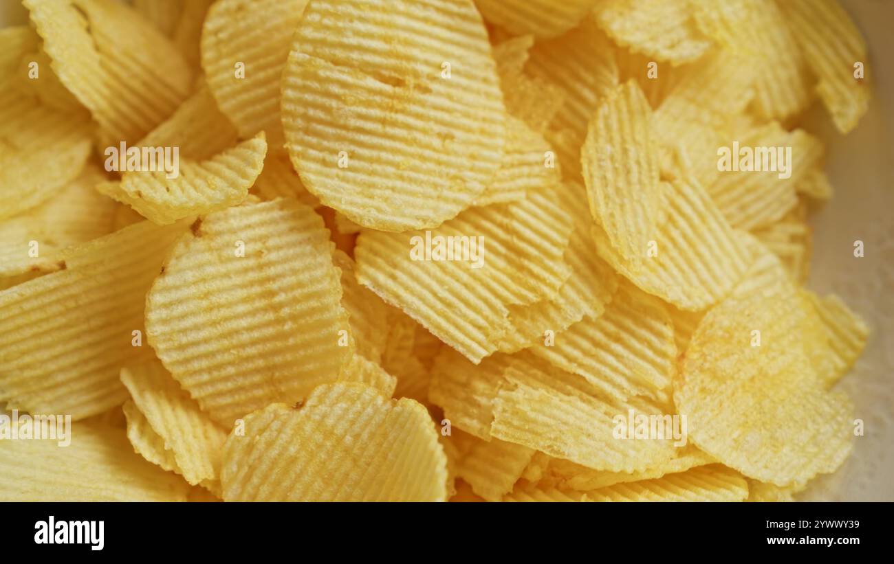 Close-up of crispy potato chips displaying their golden color and wavy ...