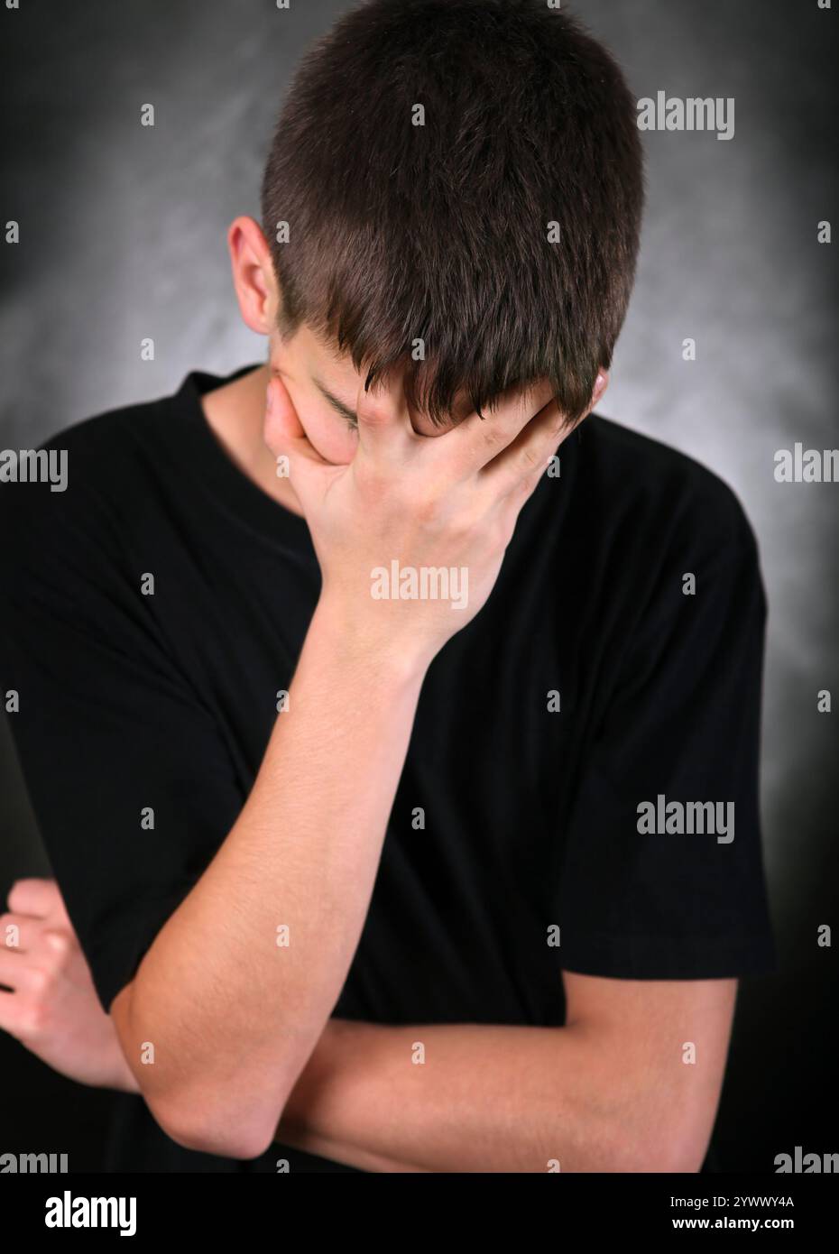 Sad Young Man On the Black Background hide his Face Stock Photo - Alamy