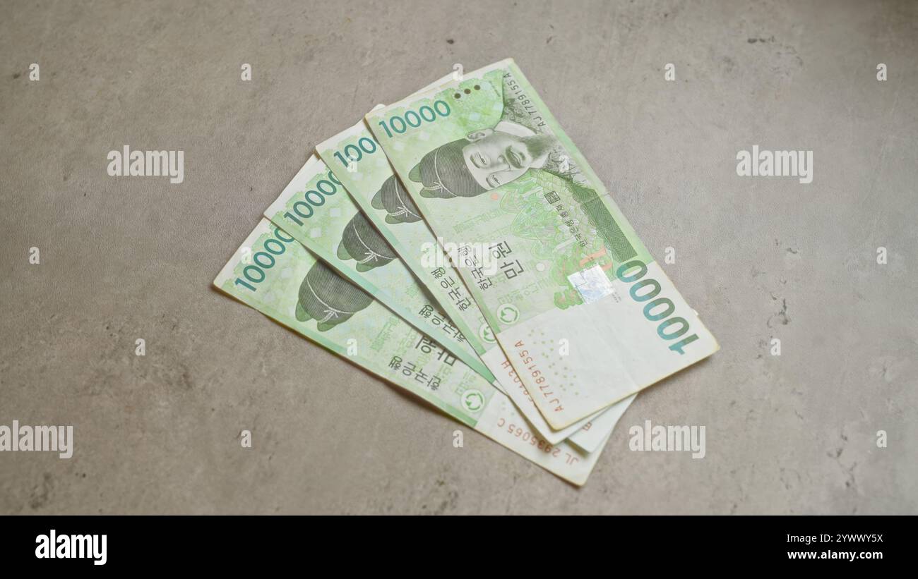 South korean banknotes laid out on a concrete surface showcasing the ...