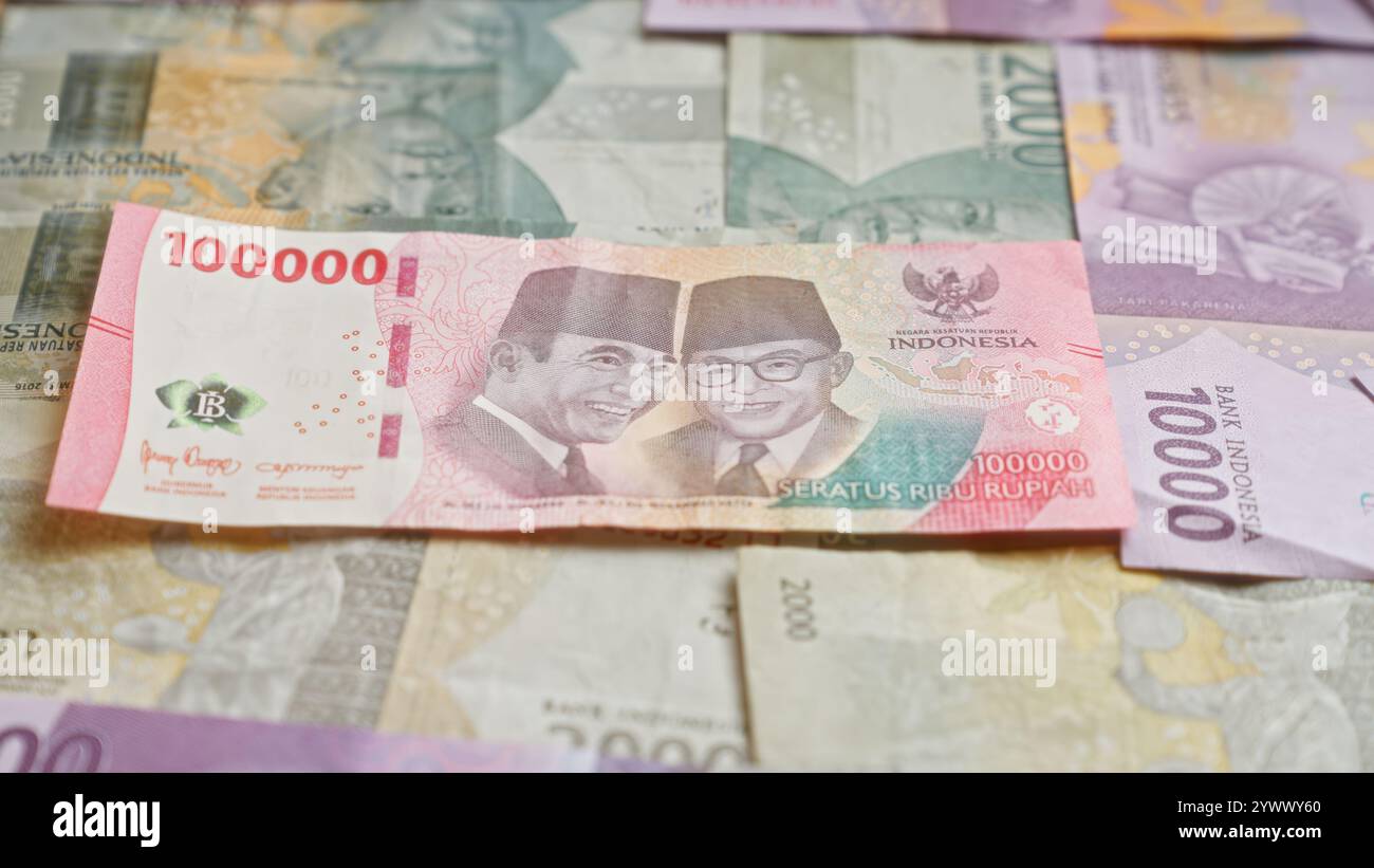 Indonesian rupiah banknotes displayed, including a prominent 100000 ...