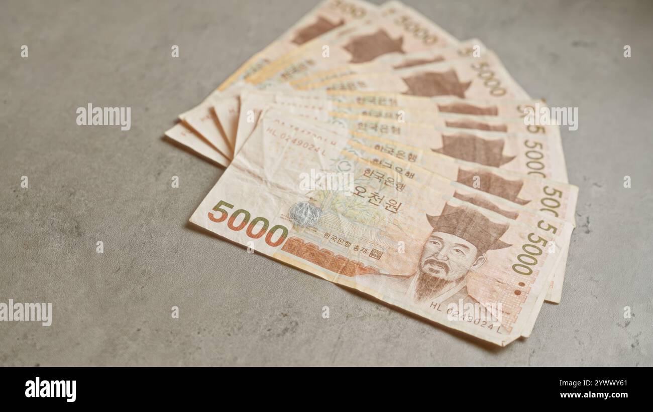 South korean banknotes spread out on a concrete surface showcasing 5000 ...