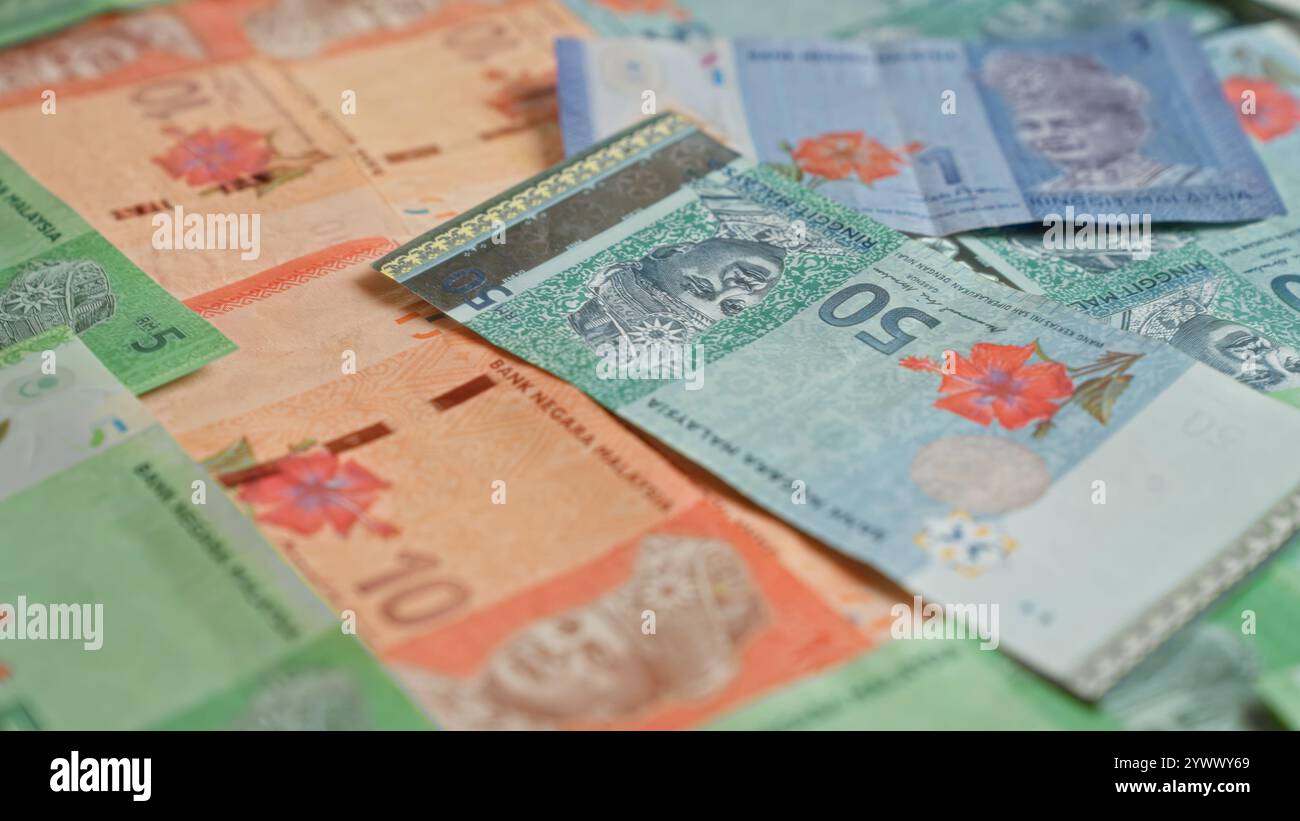 Malaysian ringgit banknotes scattered on a flat surface showcasing ...