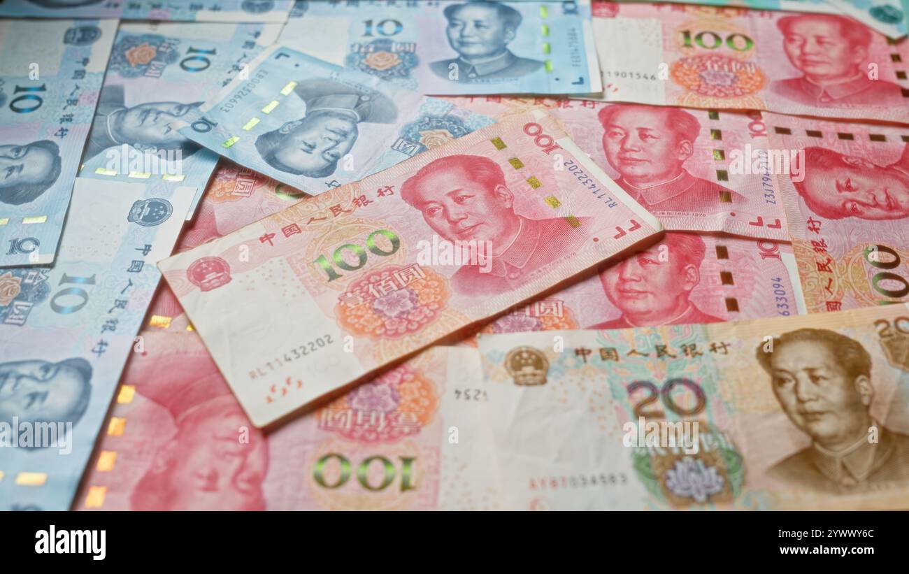 Chinese yuan banknotes spread out showcasing various denominations of ...