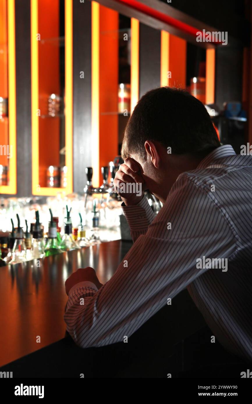 Sad and Lonely Young Man Sitting in the Darkness at the Bar counter ...