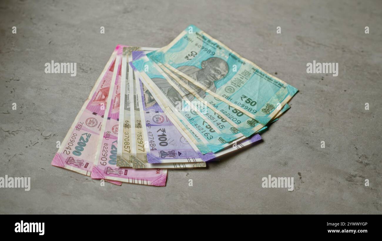 Indian rupee banknotes laying on a concrete surface, showcasing various ...